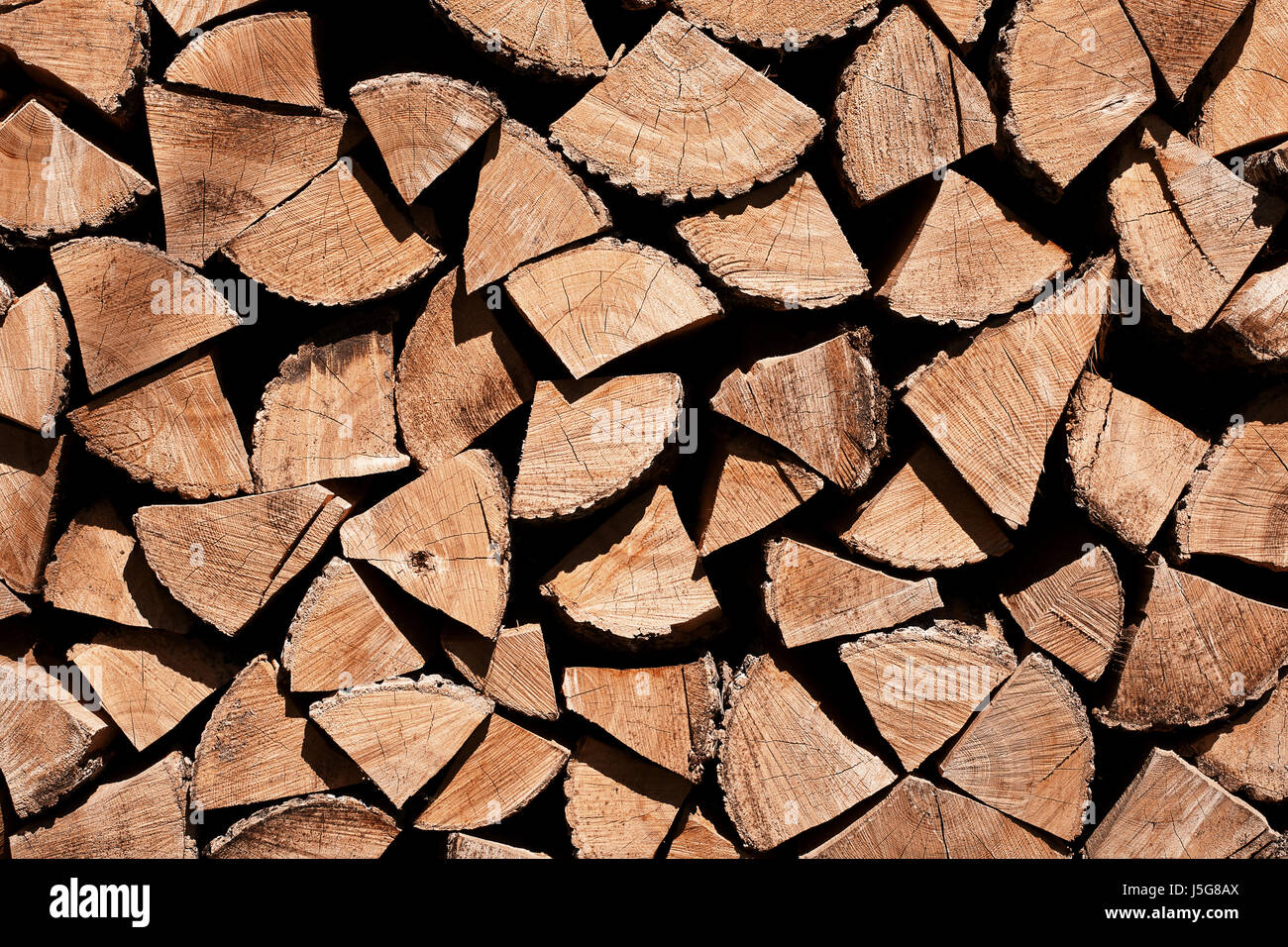 Stacked chopped fire wood texture background Stock Photo - Alamy