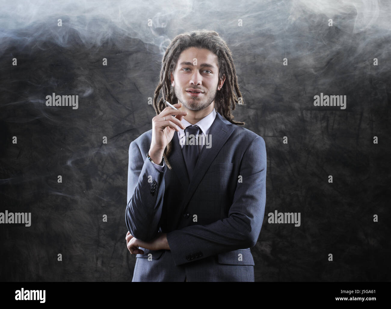 Rastafarian businessman smoking marijuana Stock Photo - Alamy