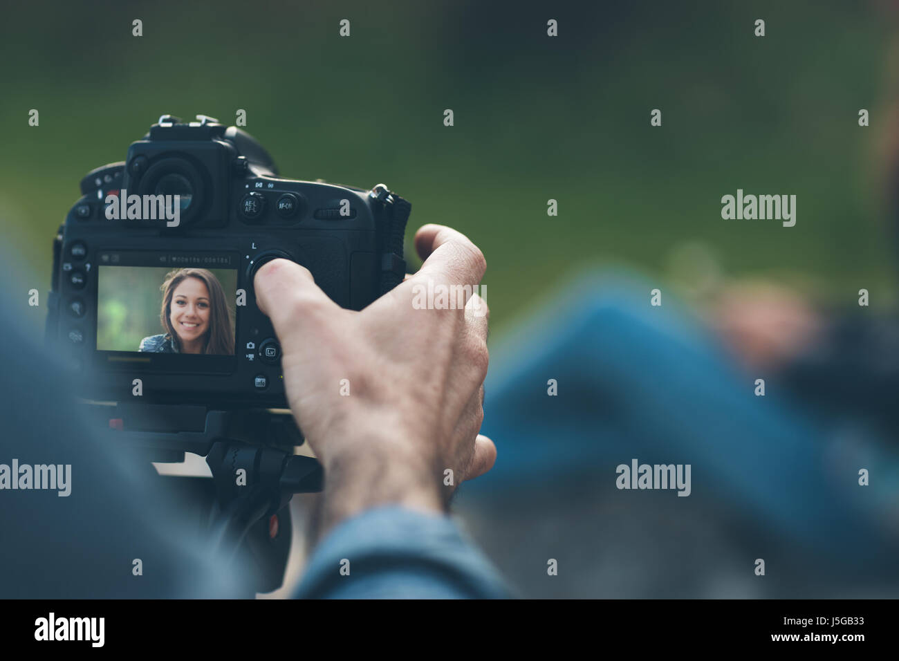 Photographer shooting hands close up and model posing on background ...