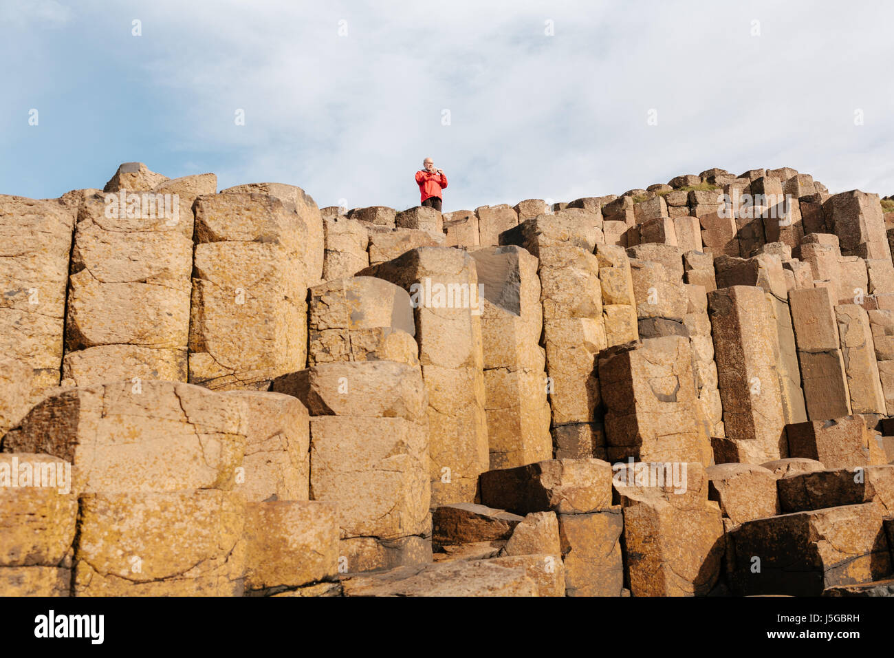 Male Tourist wearing a red jacket at The Giant's Causeway Stock Photo ...