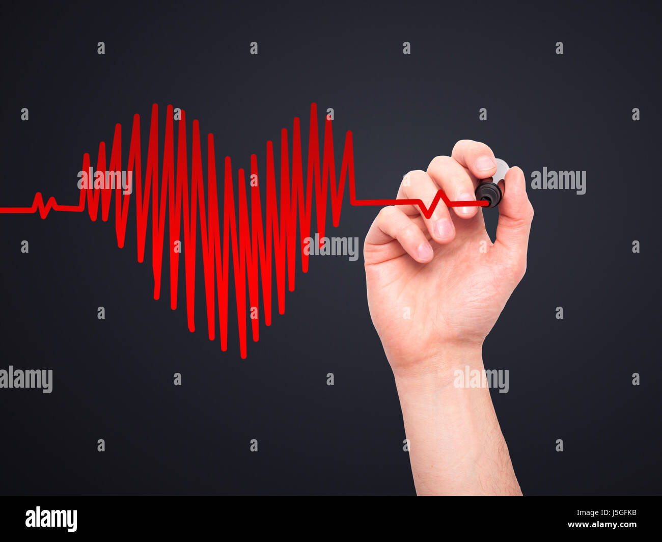 Closeup of hand drawing heart beat in heart shape with stethoscope ...