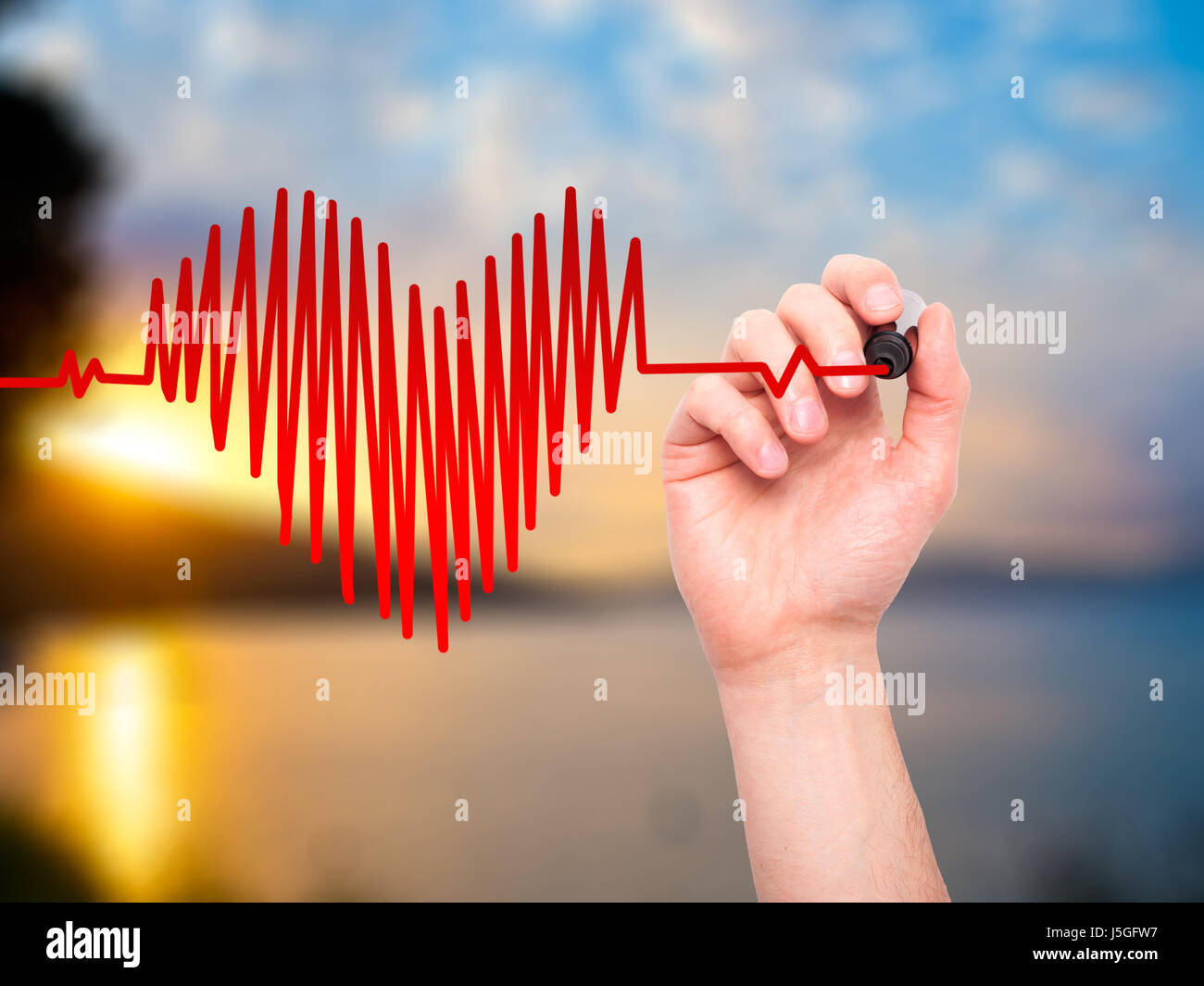 Closeup of hand drawing heart beat in heart shape with stethoscope ...
