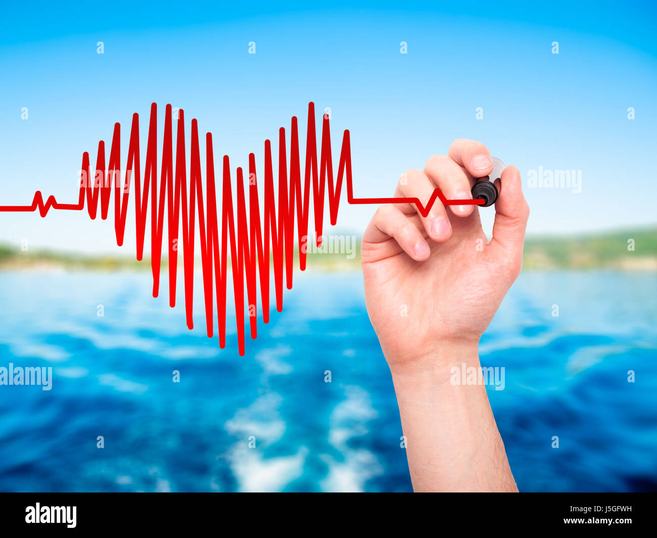 Closeup of hand drawing heart beat in heart shape with stethoscope ...