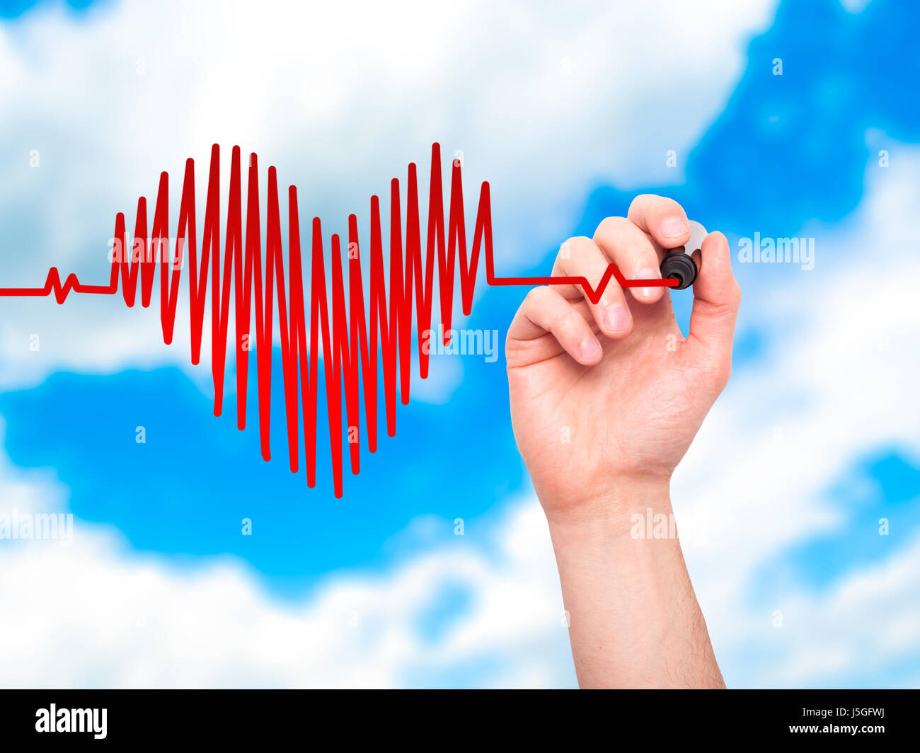 Closeup of hand drawing heart beat in heart shape with stethoscope ...