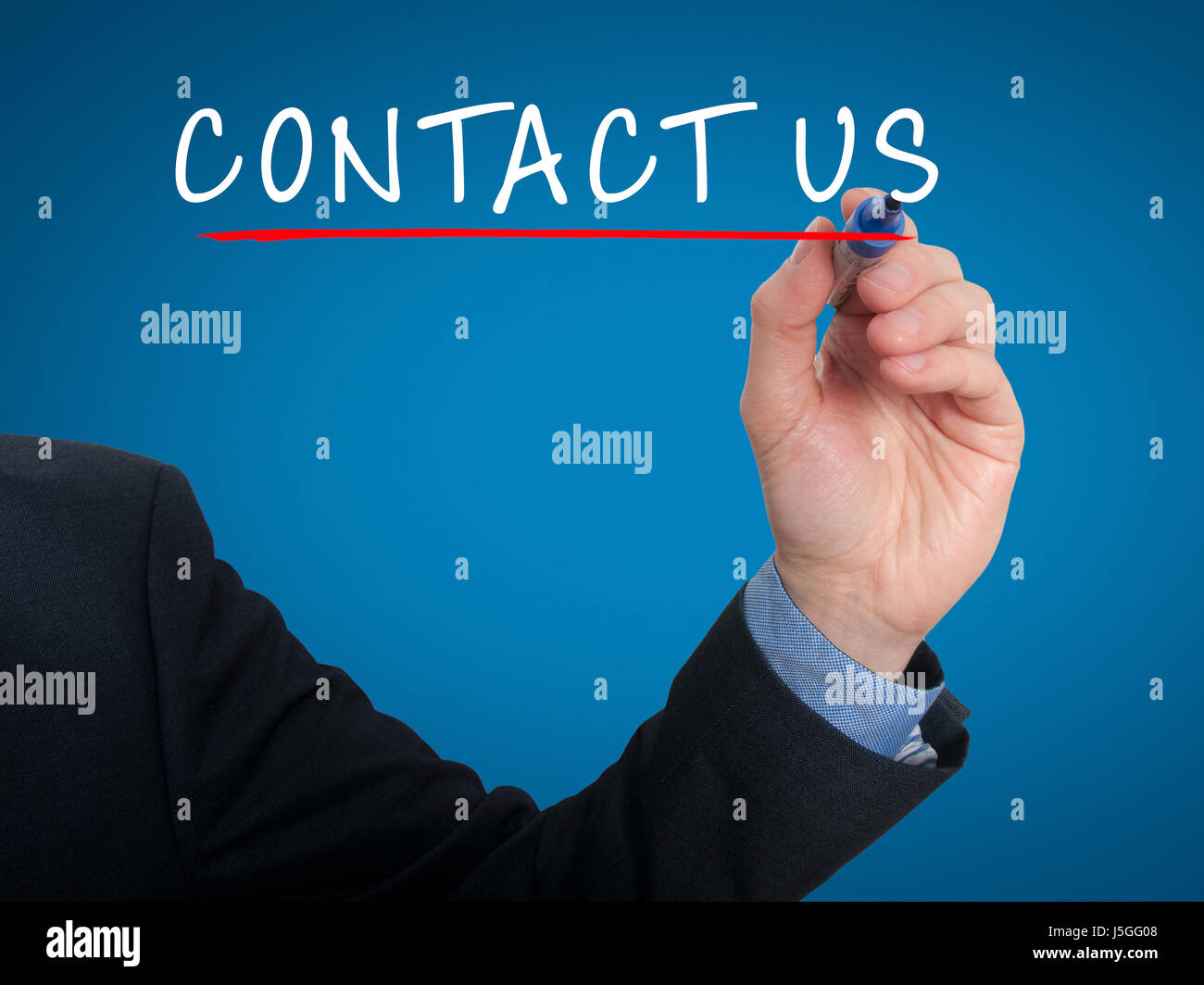 Businessman hand writing contact us. Blue Stock Photo - Alamy