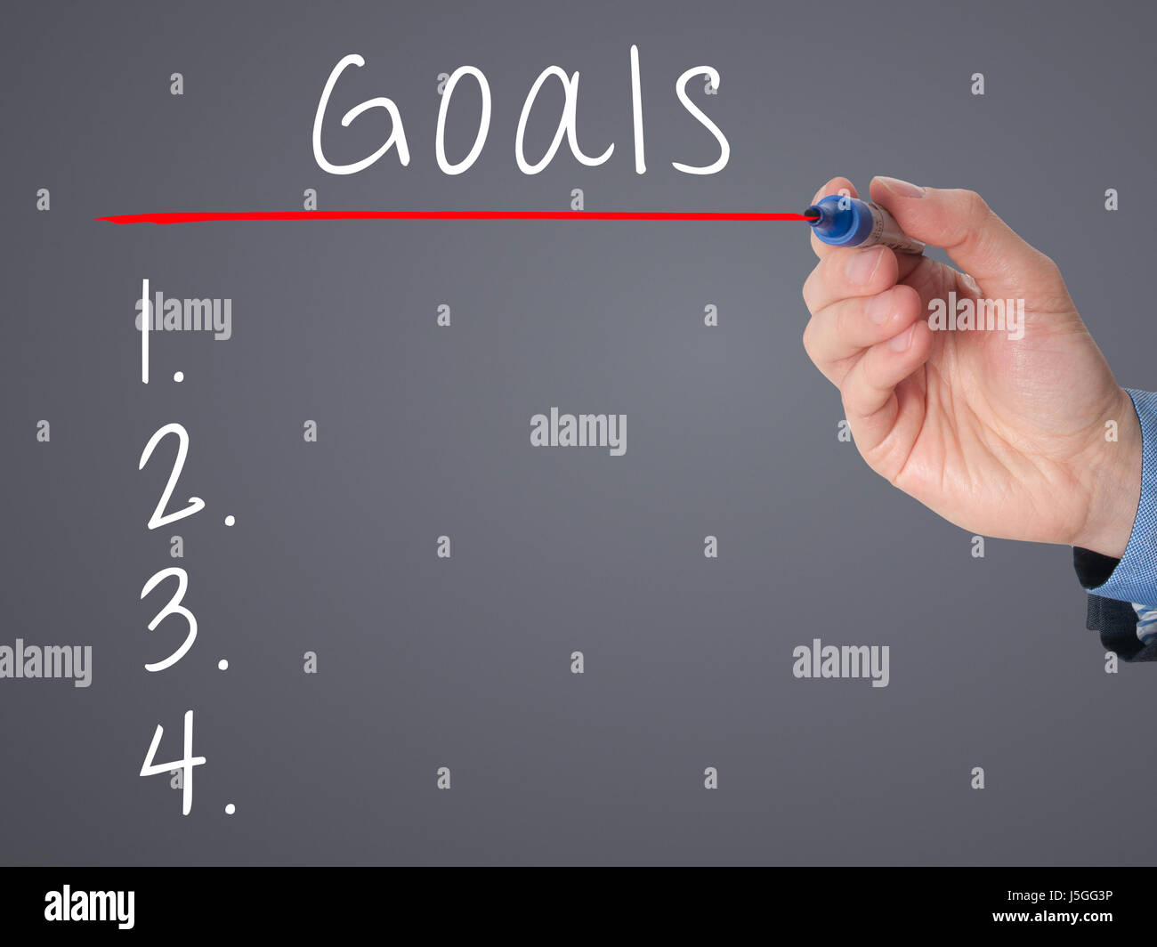 Businessman is writing goals list, planning on whiteboard. Isolated on ...