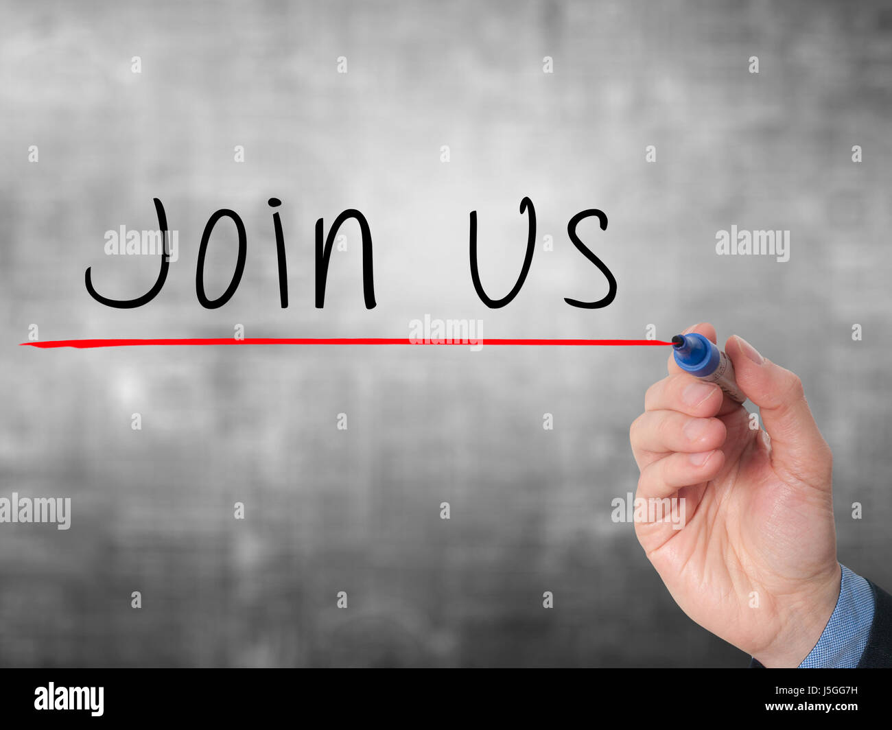 join us words written by businessman hand on a transparent board ...