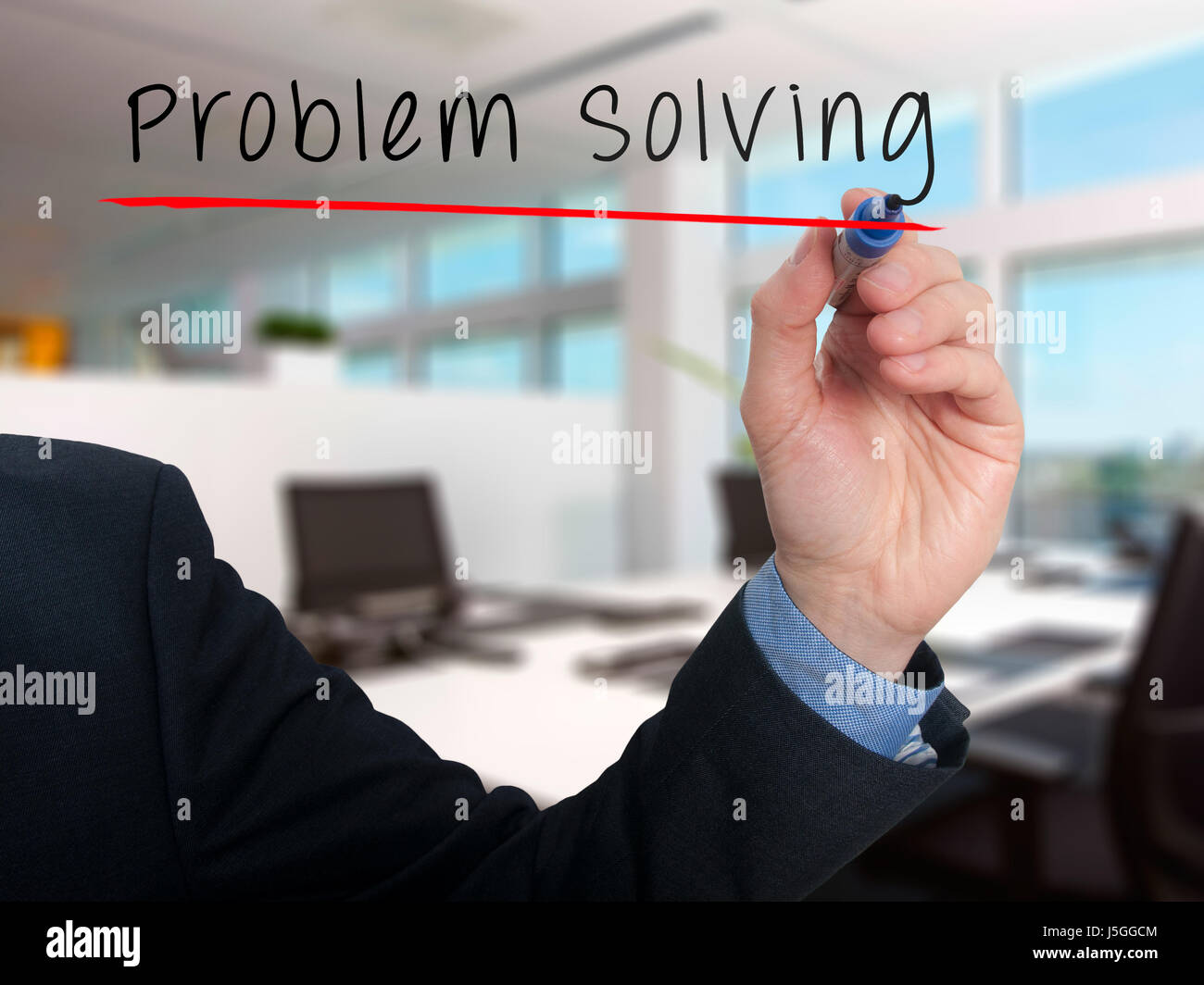 Businessman is writing Problem Solving on the transparent board ...