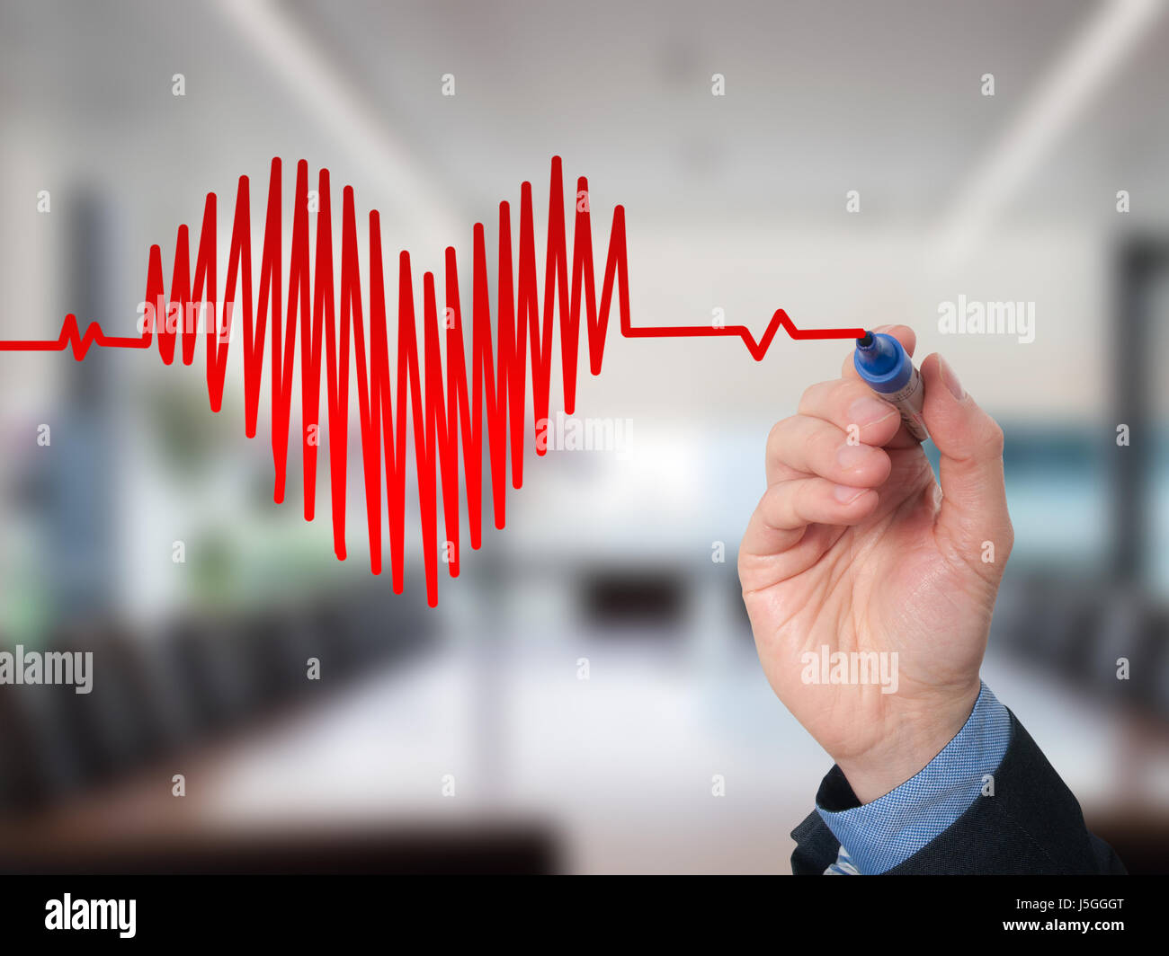 Businessman hand drawing chart heartbeat. Isolated on office background ...