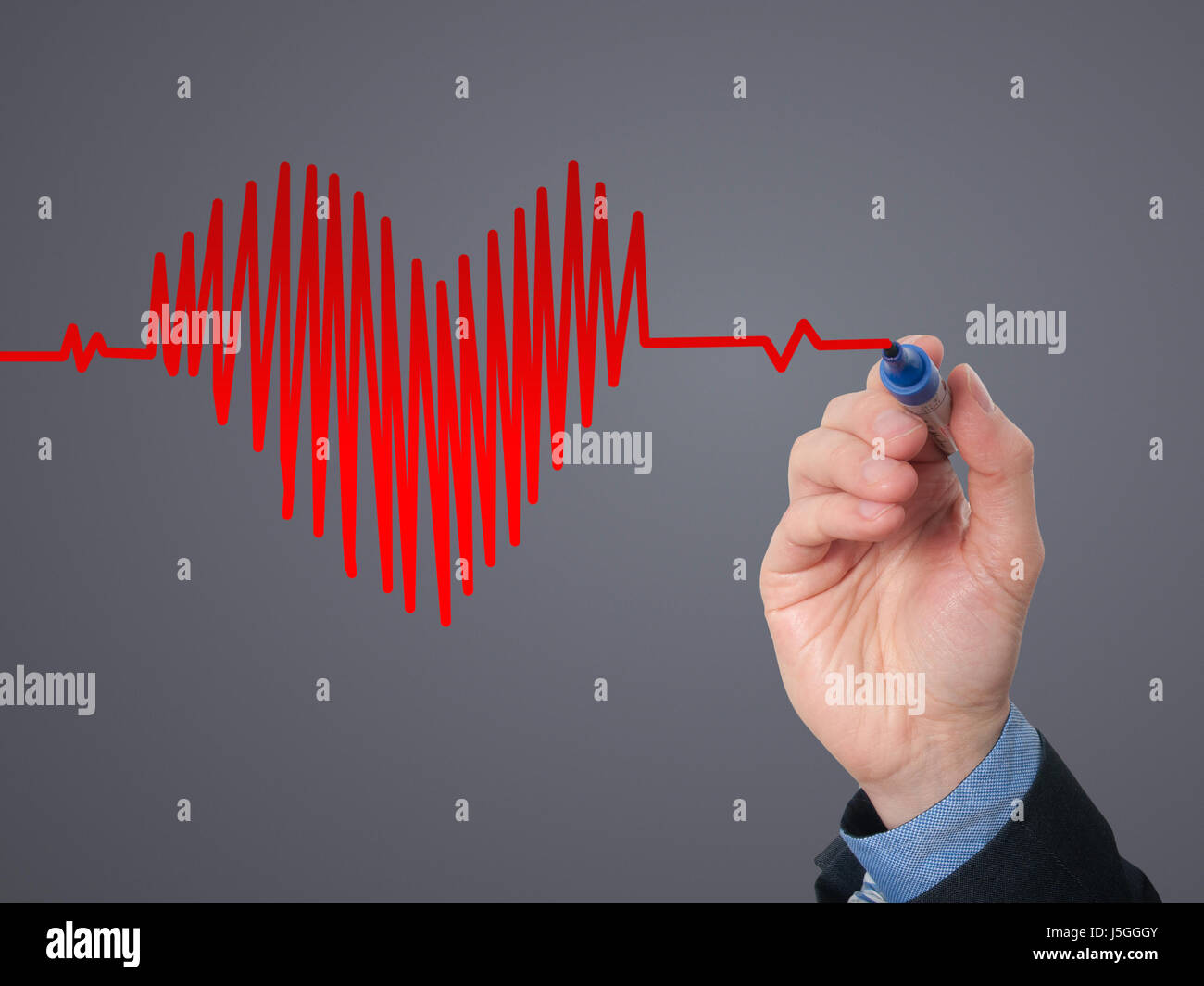 Businessman hand drawing chart heartbeat. Isolated on grey background ...