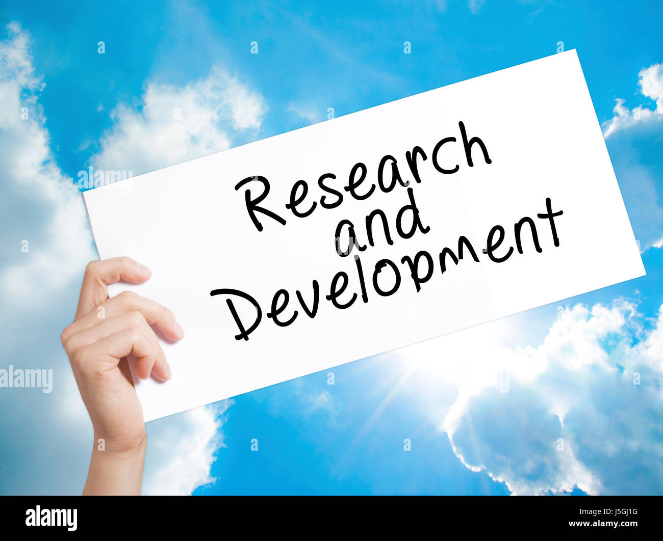 Research and Development Sign on white paper. Man Hand Holding Paper ...