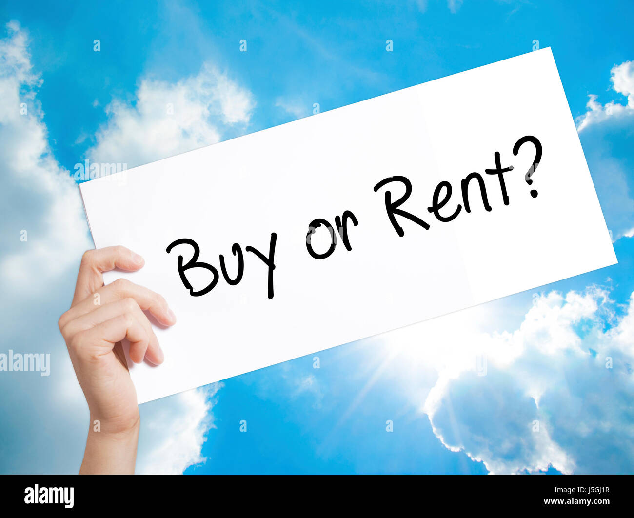 Buy or Rent? Sign on white paper. Man Hand Holding Paper with text ...