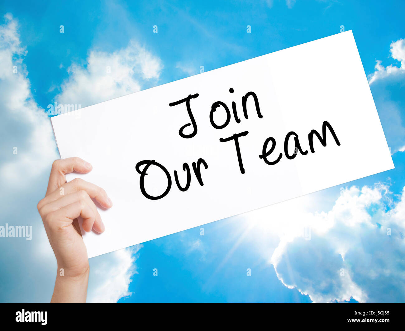 Join Our Team Sign on white paper. Man Hand Holding Paper with text ...