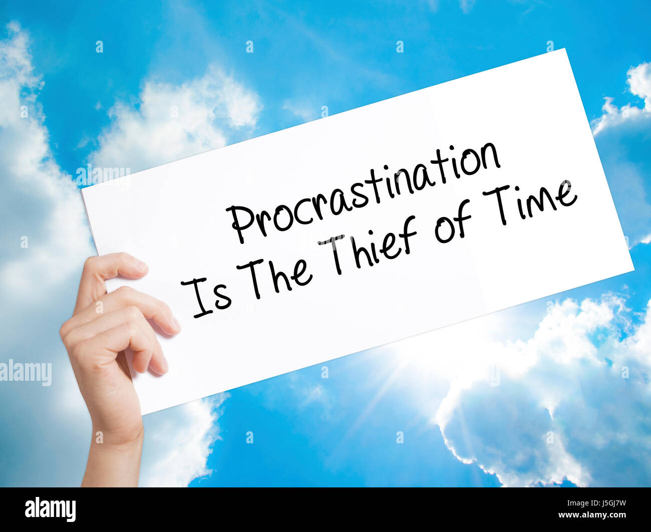 Procrastination Is The Thief of Time Sign on white paper. Man Hand ...