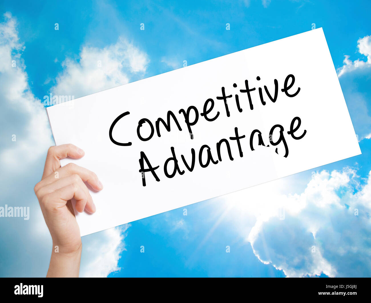 Competitive Advantage Sign on white paper. Man Hand Holding Paper with ...