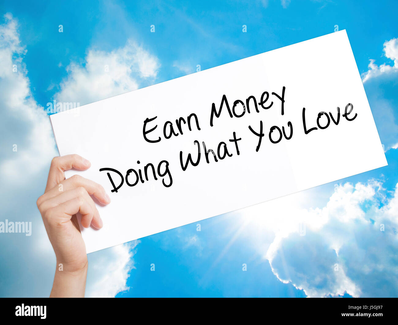 Earn Money Doing What You Love Sign on white paper. Man Hand Holding ...
