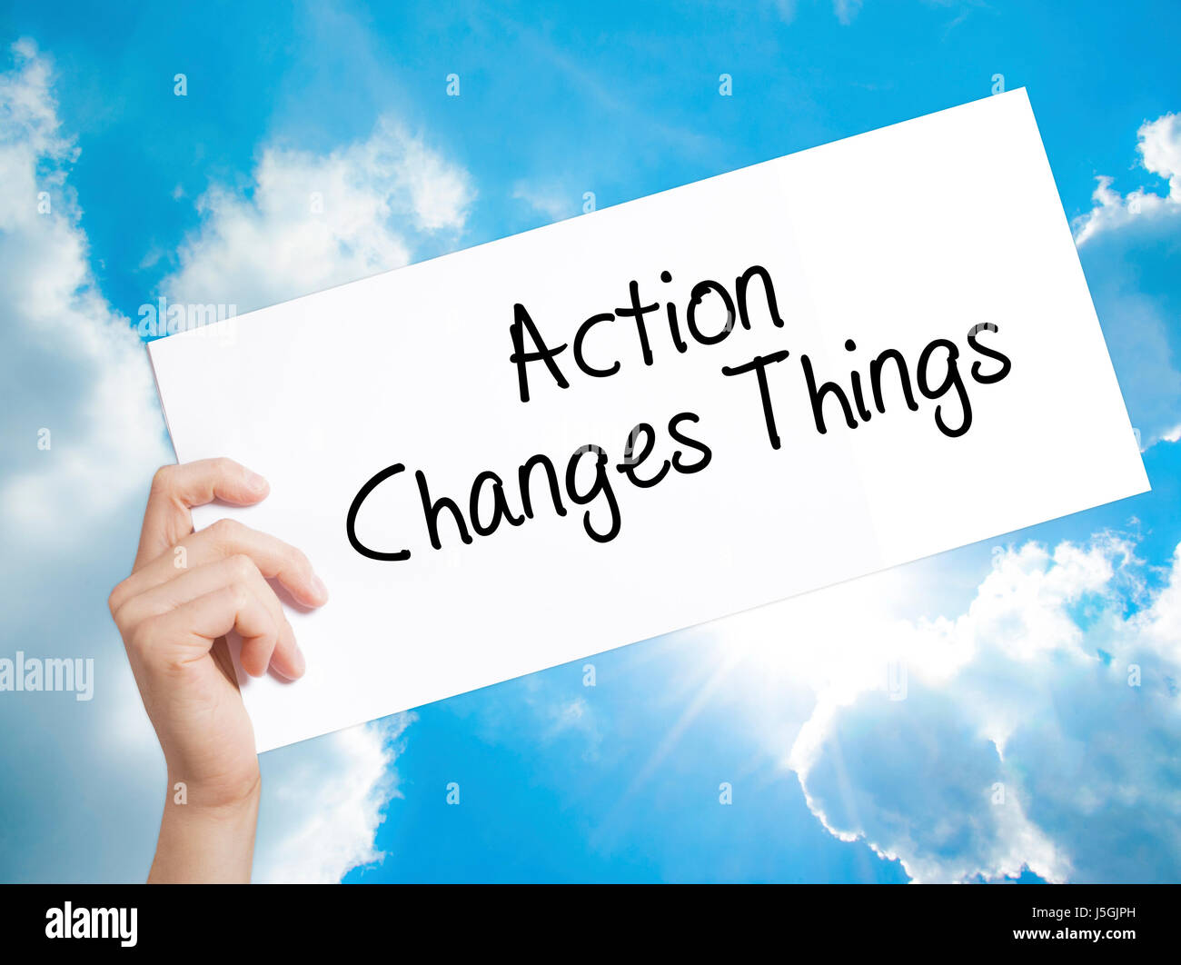 Action Changes Things Sign on white paper. Man Hand Holding Paper with ...