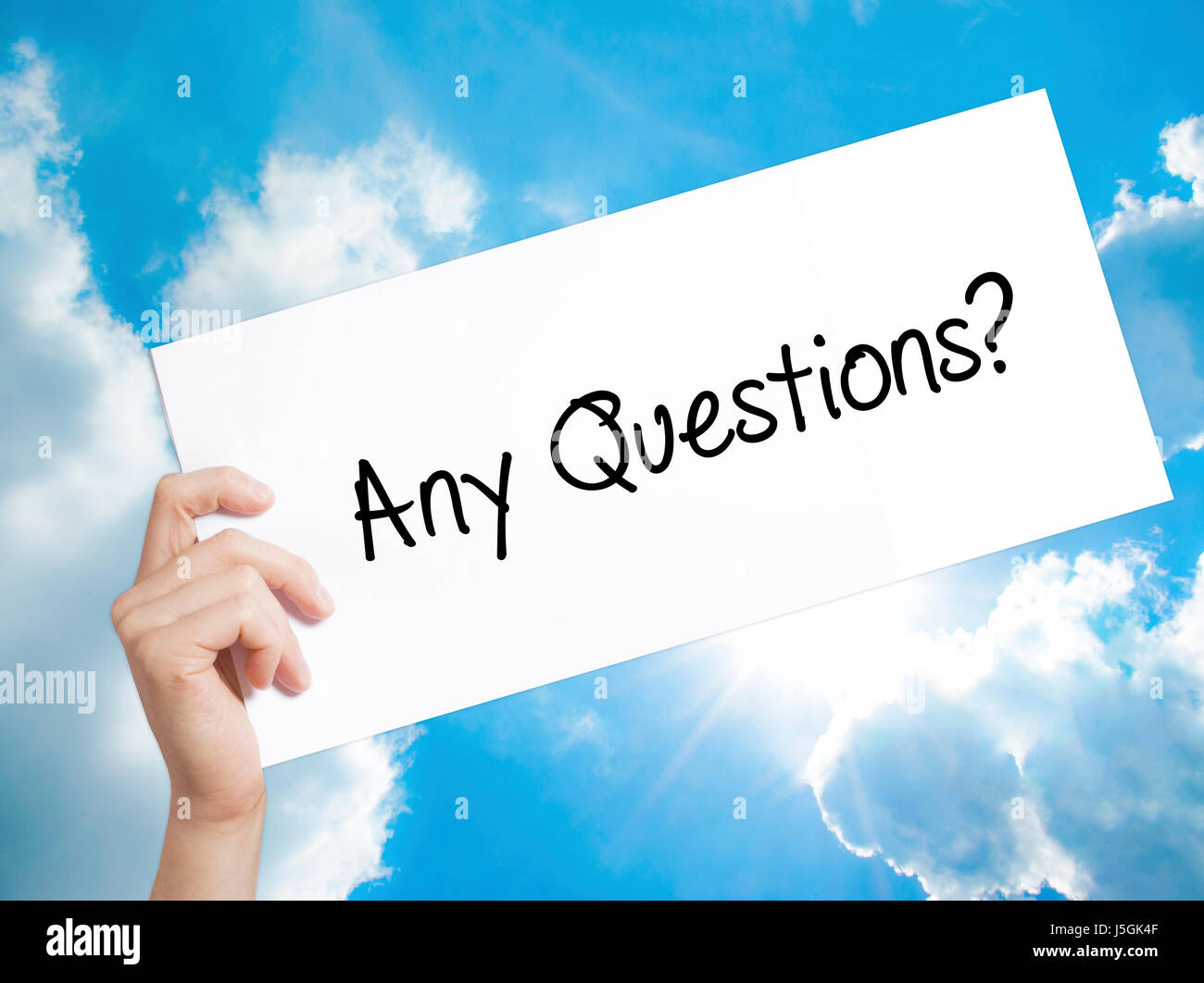 Any Questions? Sign on white paper. Man Hand Holding Paper with text ...