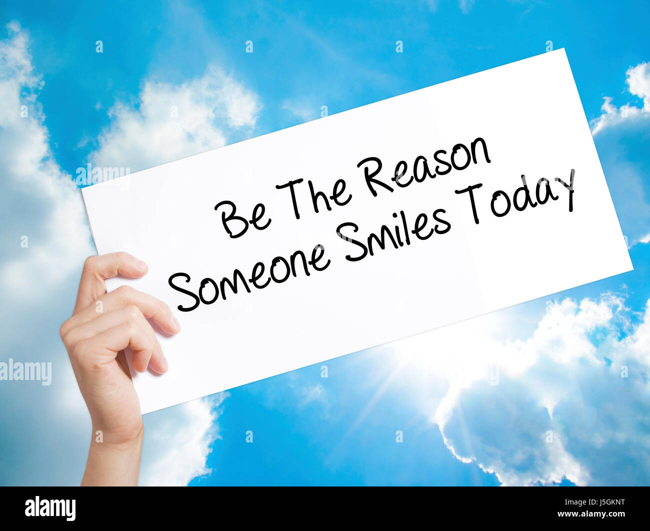 Be The Reason Someone Smiles Today Sign on white paper. Man Hand ...