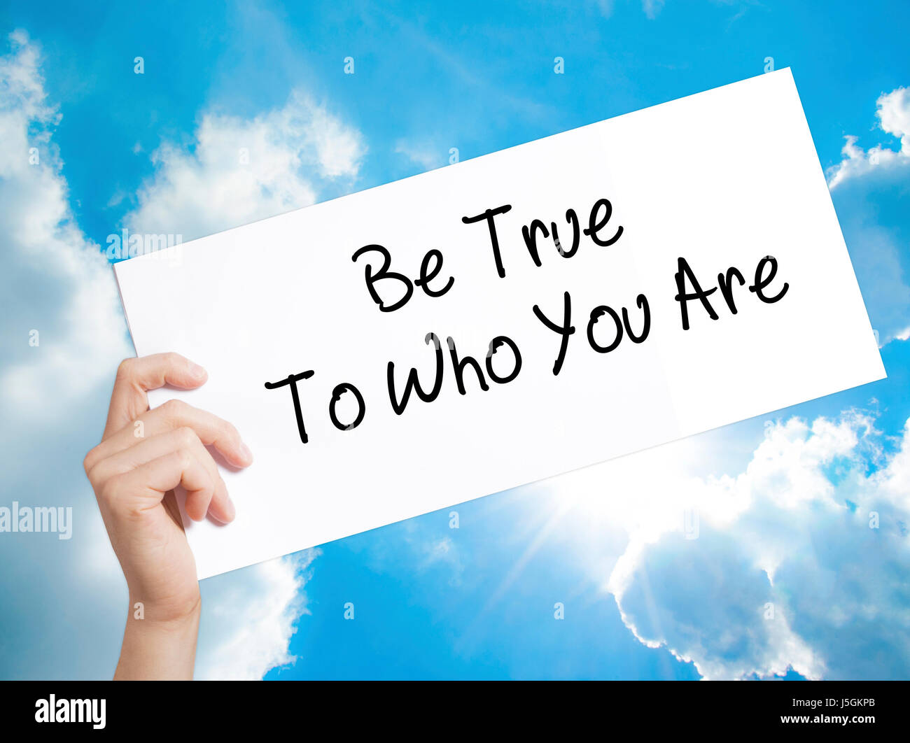 Be True To Who You Are Sign on white paper. Man Hand Holding Paper with ...