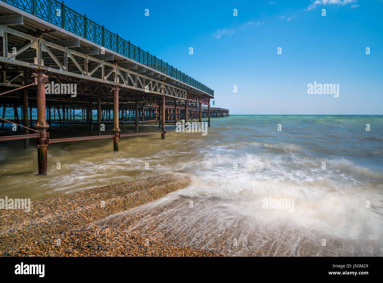A pier and stony beach in Hastings, East Sussex UK Stock Photo - Alamy