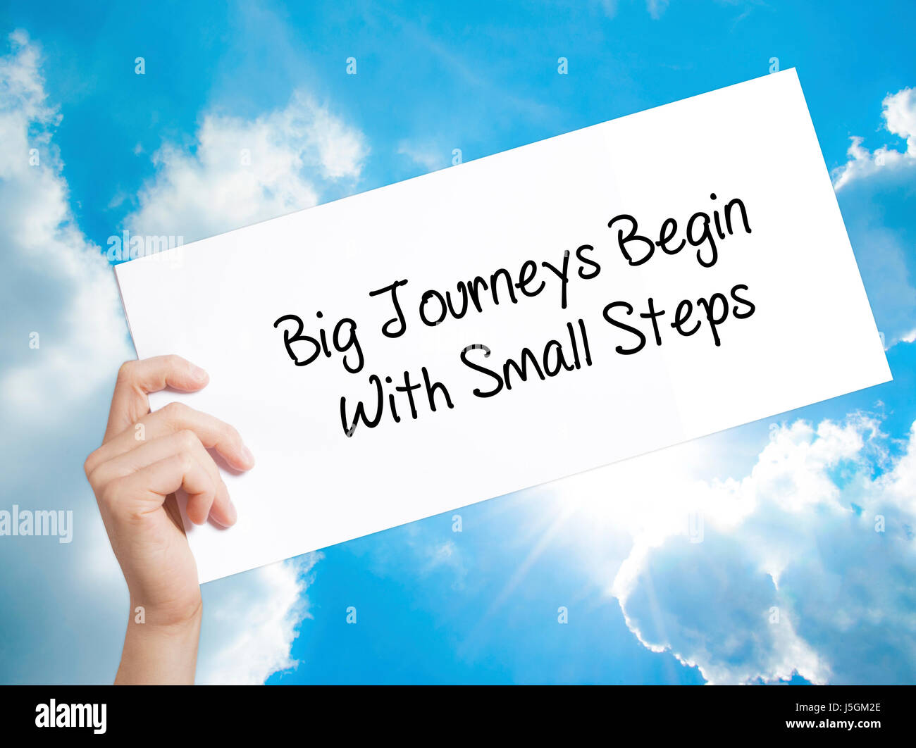Big Journeys Begin With Small Steps Sign on white paper. Man Hand ...