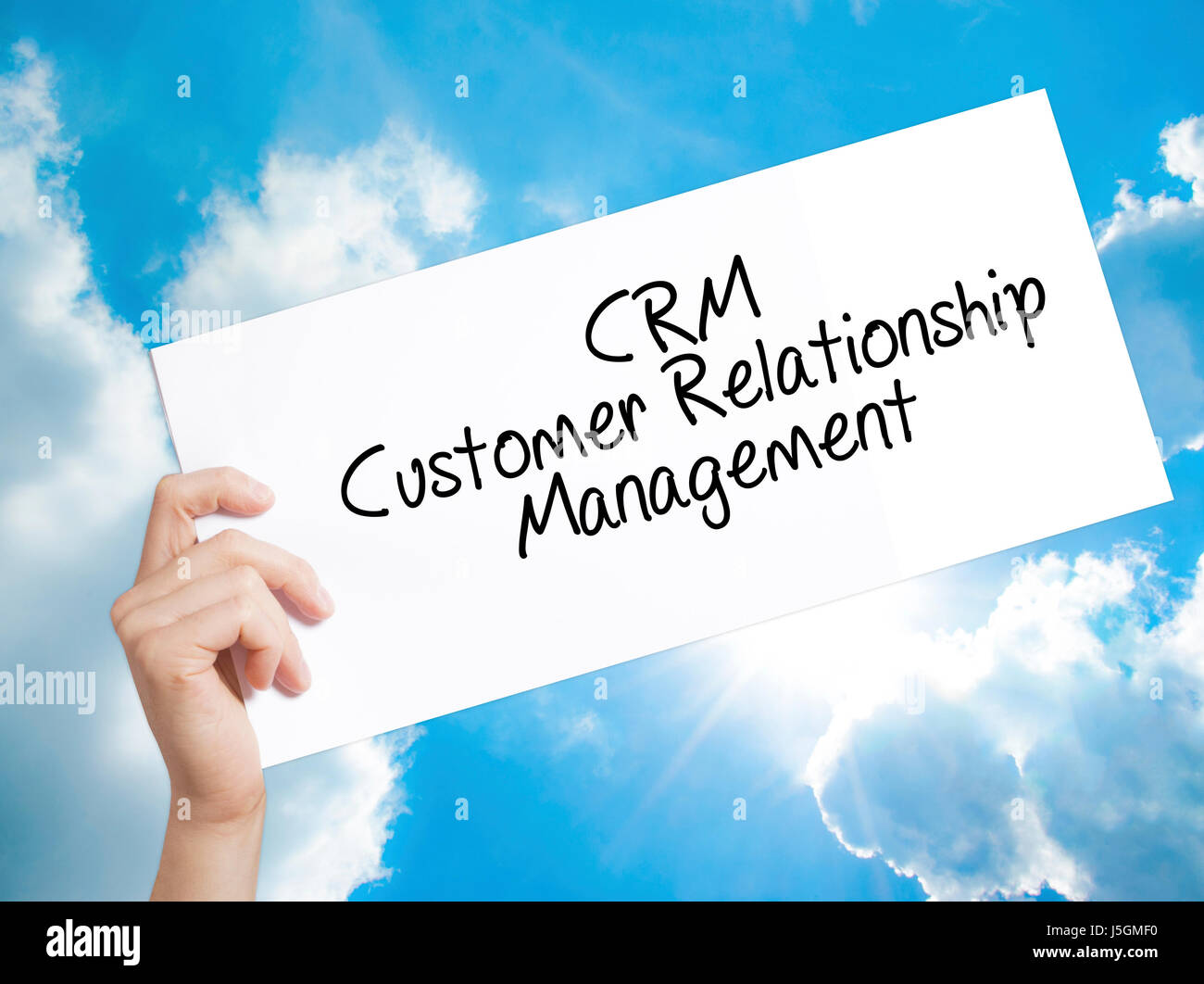 CRM Customer Relationship Management Sign on white paper. Man Hand ...