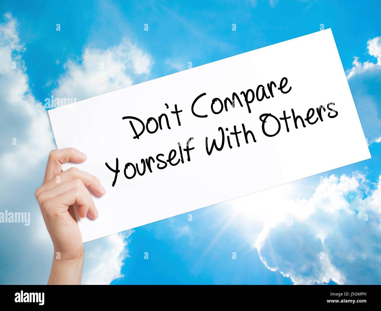 Don't Compare Yourself With Others Sign on white paper. Man Hand ...