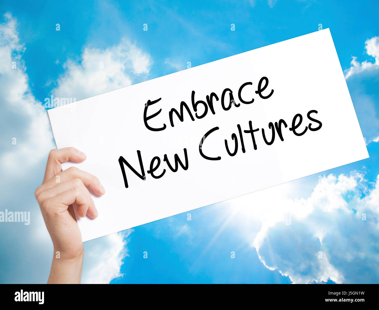 Embrace New Cultures Sign on white paper. Man Hand Holding Paper with ...