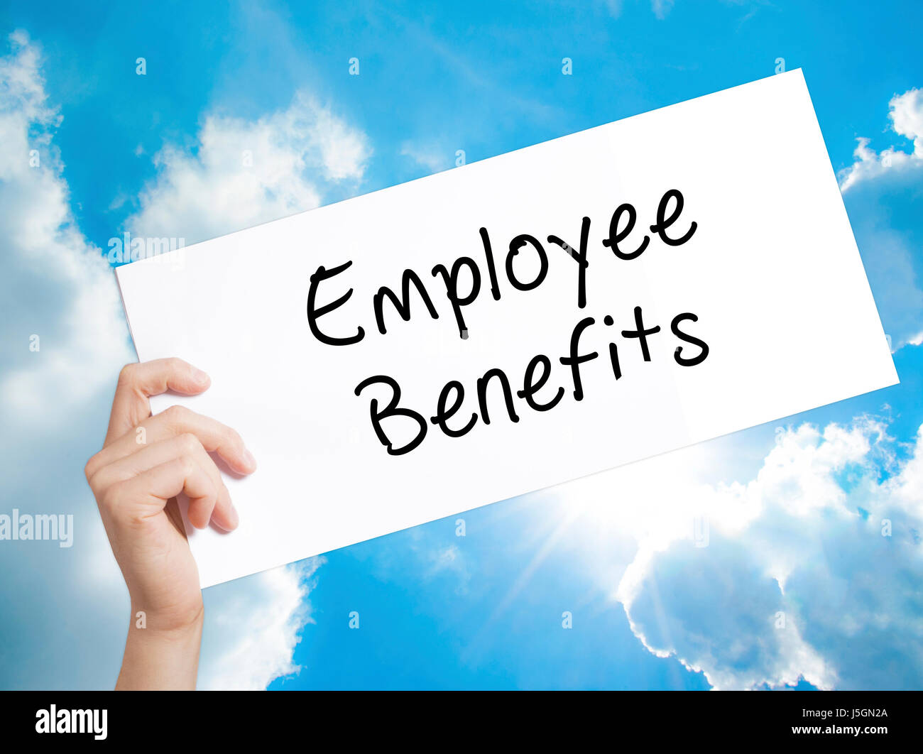 Employee Benefits Sign on white paper. Man Hand Holding Paper with text ...