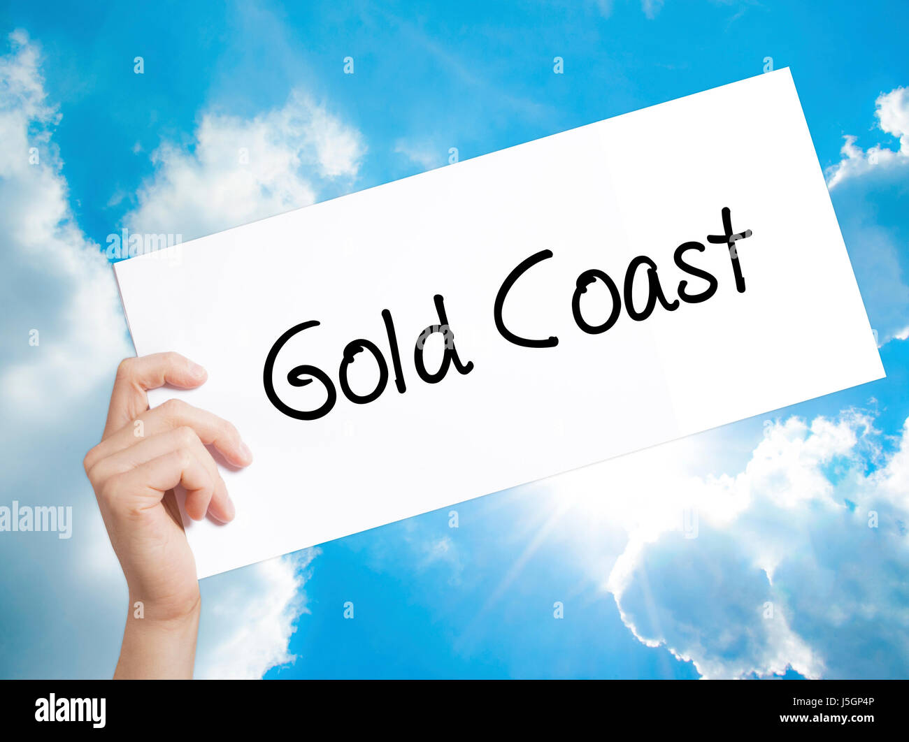 Gold Coast Sign on white paper. Man Hand Holding Paper with text ...