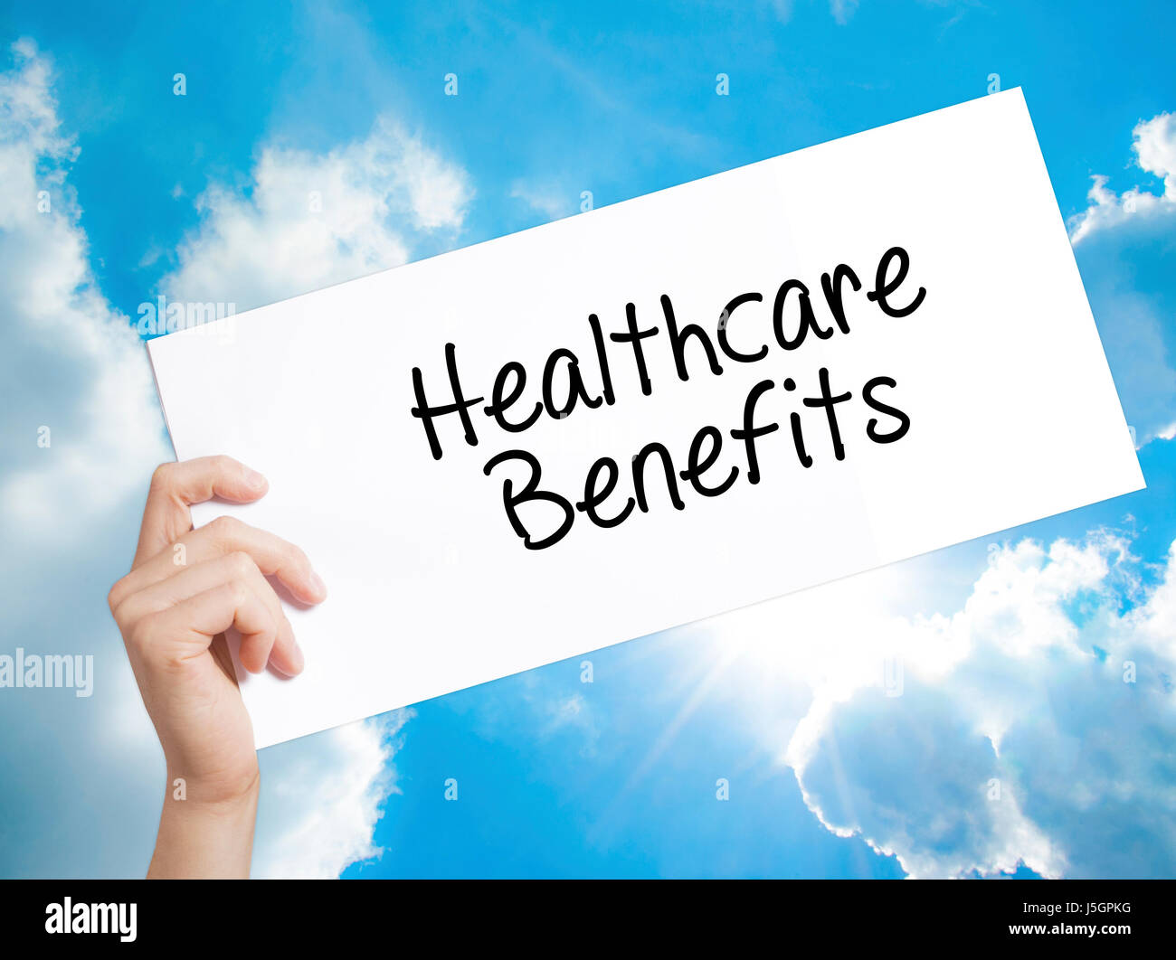 Healthcare Benefits Sign on white paper. Man Hand Holding Paper with ...