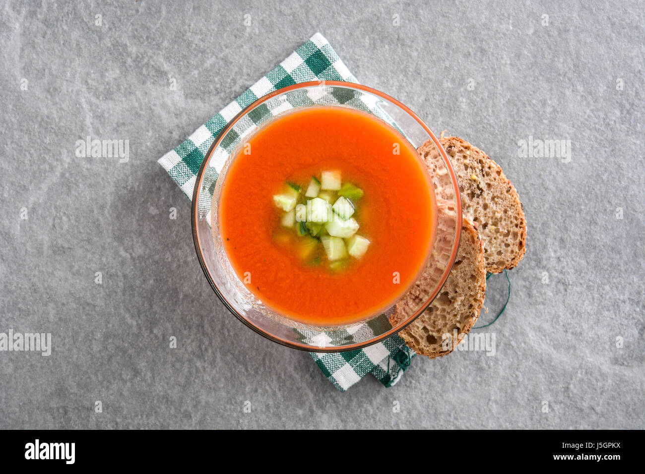 Traditional Spanish cold gazpacho soup and ingredients on gray stone ...