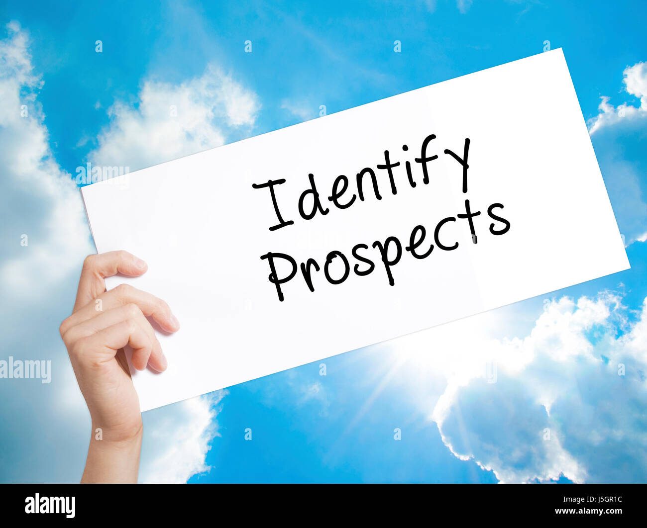 Identify Prospects Sign on white paper. Man Hand Holding Paper with ...