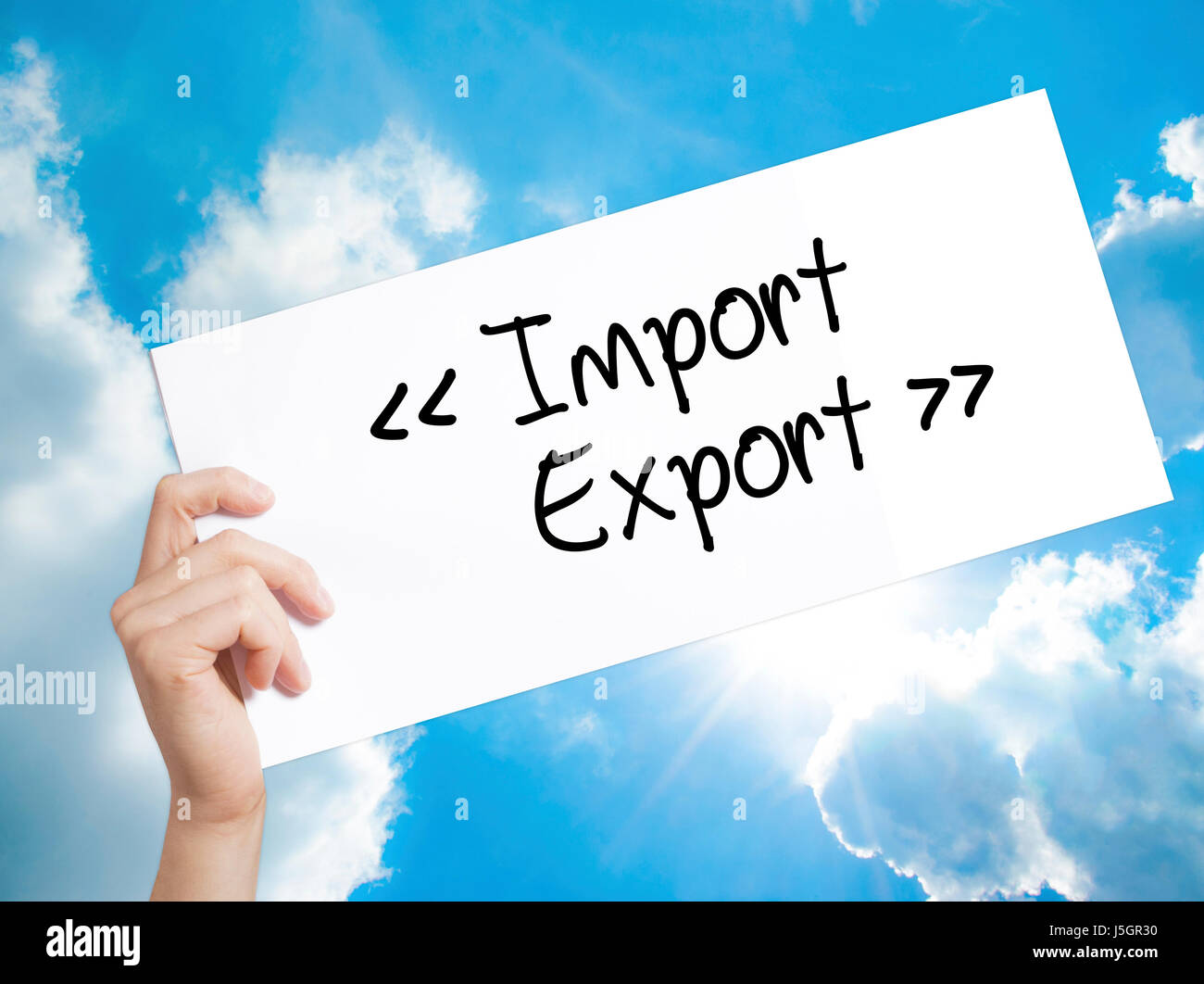 Import - Export Sign on white paper. Man Hand Holding Paper with text ...