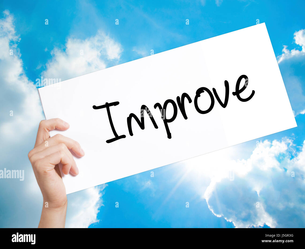 Improve Sign on white paper. Man Hand Holding Paper with text. Isolated ...