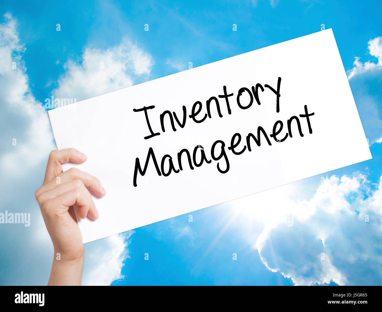 Inventory Management Sign on white paper. Man Hand Holding Paper with ...