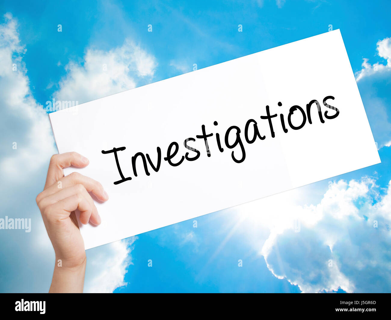 Investigations Sign on white paper. Man Hand Holding Paper with text ...