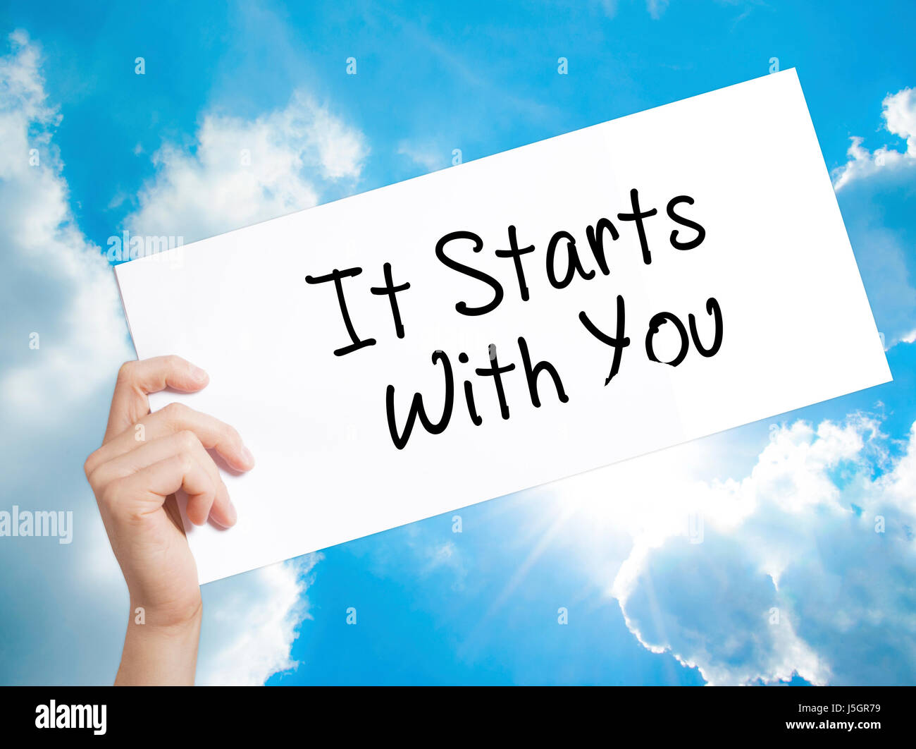 It Starts With You Sign on white paper. Man Hand Holding Paper with ...