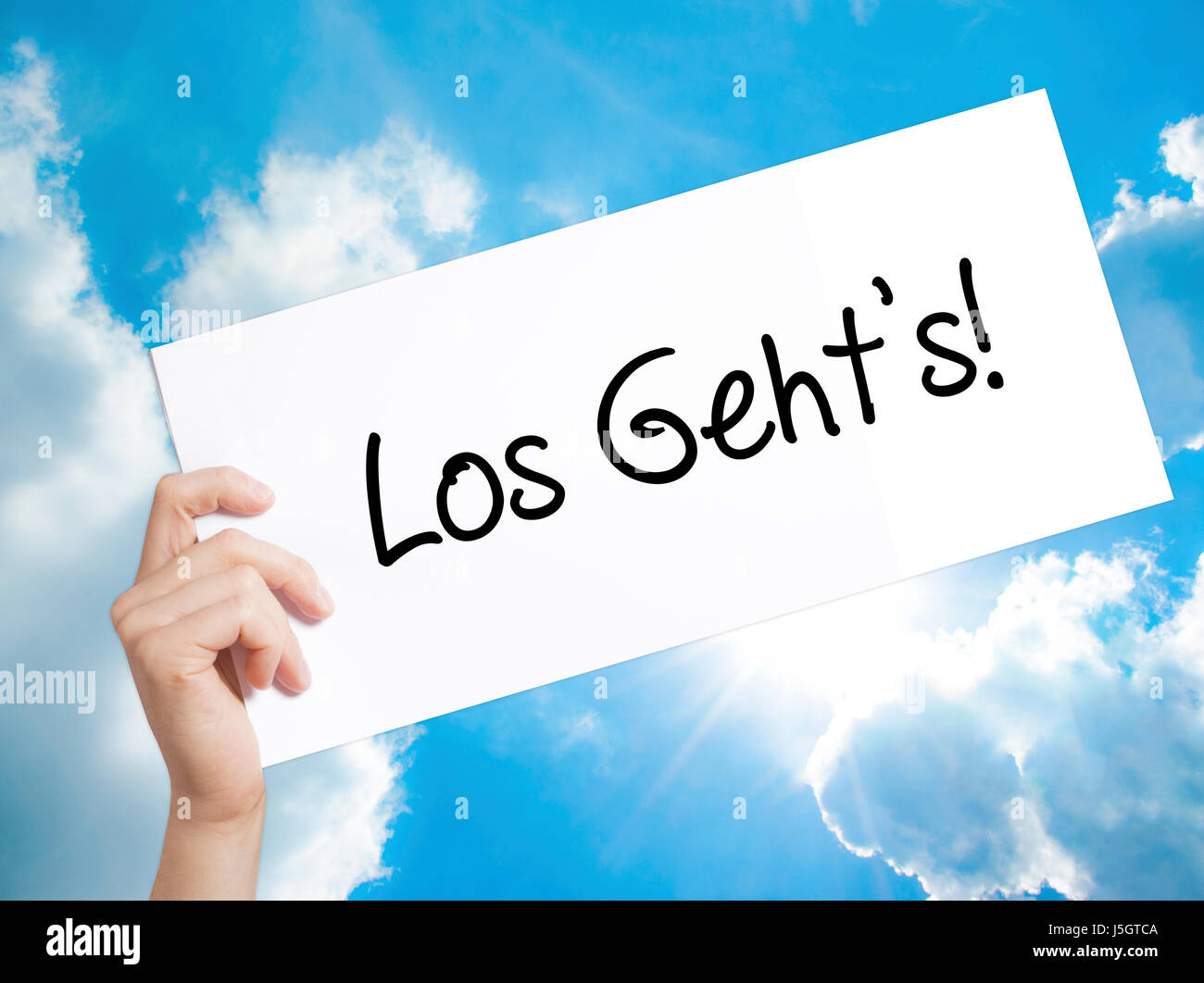 Los geht's! (Here We Go in German) Sign on white paper. Man Hand ...