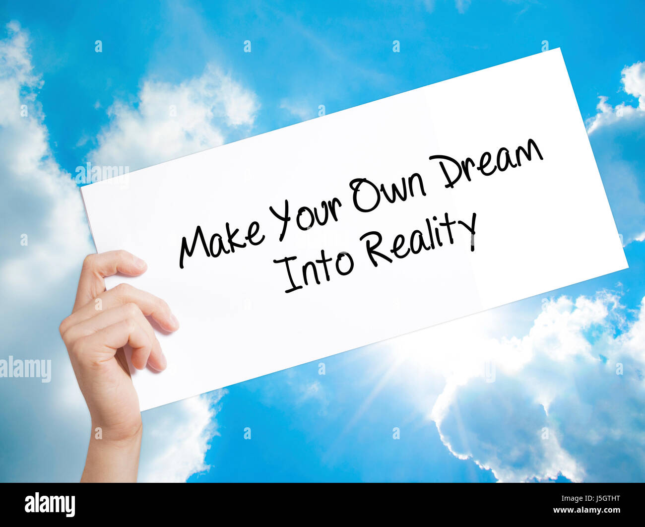 Make Your Own Dream Into Reality Sign on white paper. Man Hand Holding ...