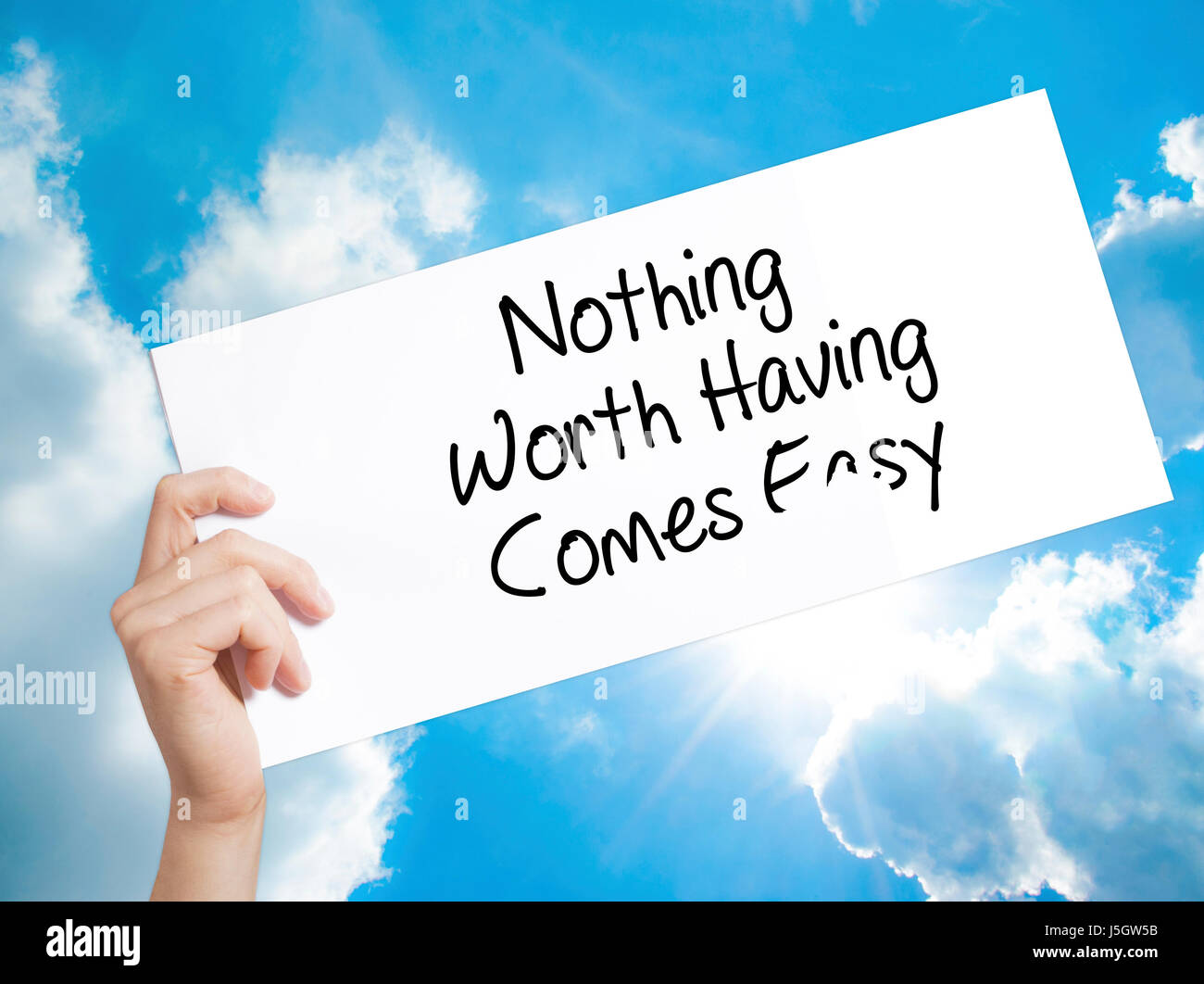 Nothing Worth Having Comes Easy Sign on white paper. Man Hand Holding ...