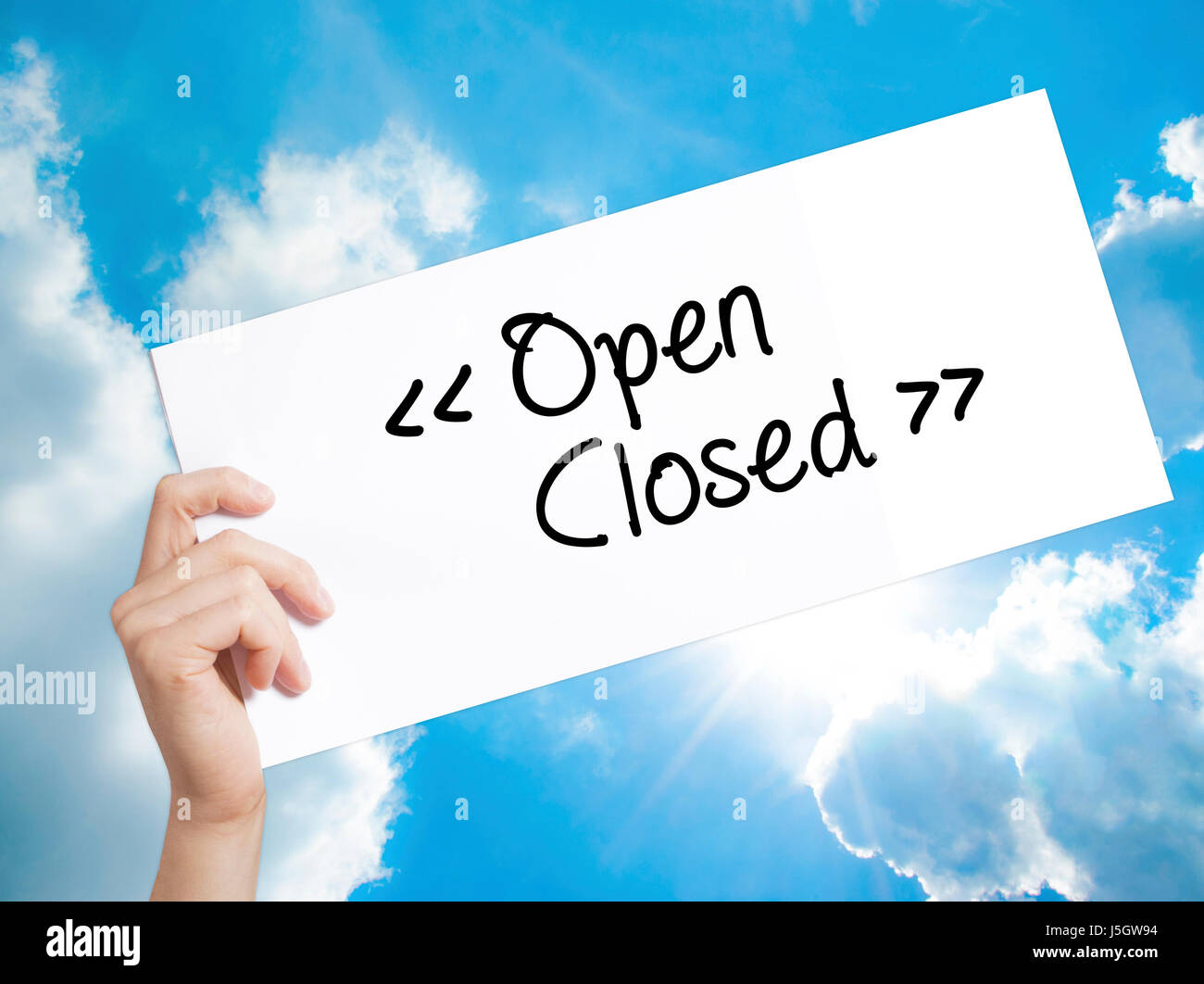 Open - Closed Sign on white paper. Man Hand Holding Paper with text ...