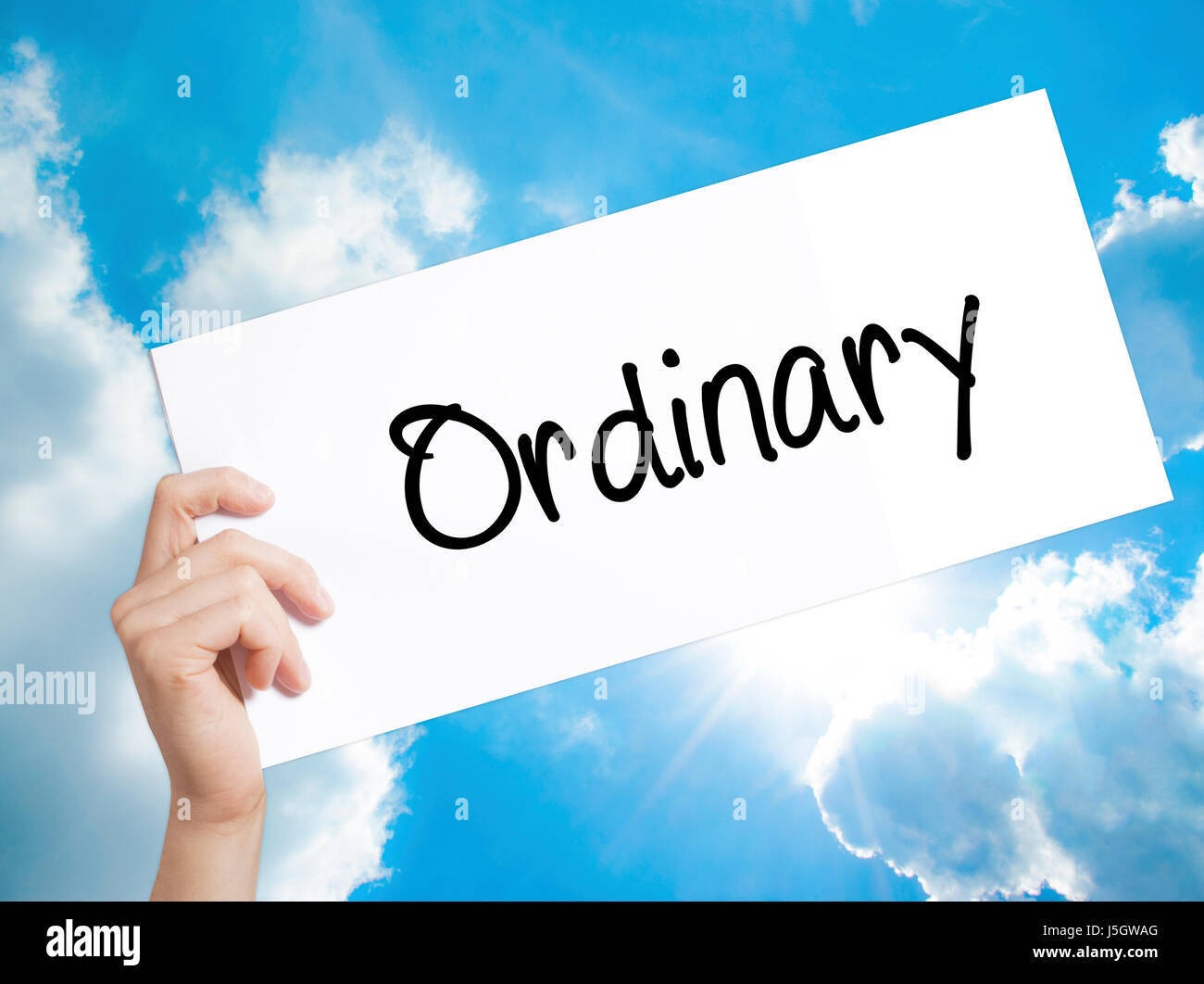 Ordinary Sign on white paper. Man Hand Holding Paper with text ...