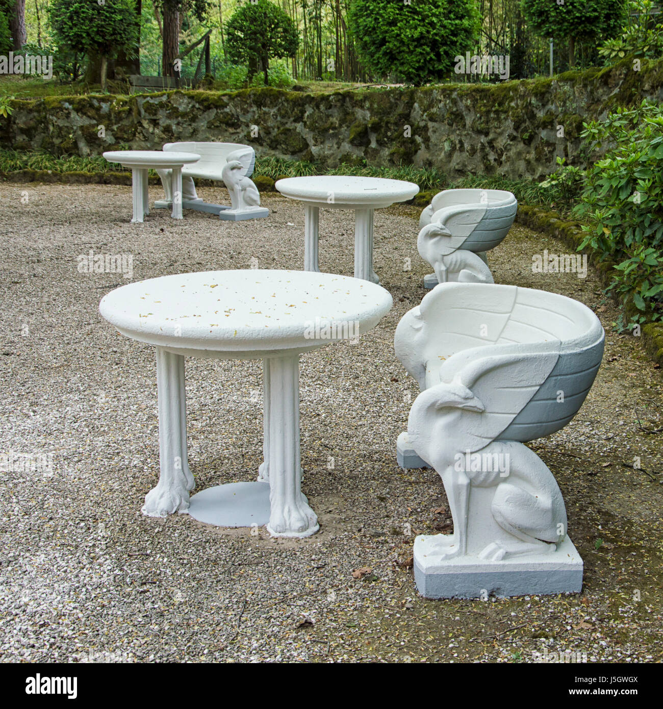 White stone benches with sculpted griffin shape, architecture of 900's ...
