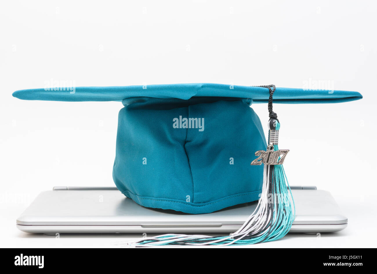 Cap, tassel and laptop graduation Stock Photo - Alamy