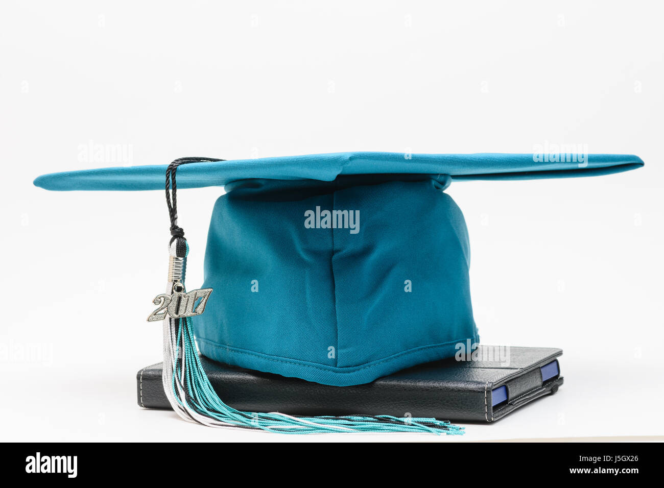 Graduation cap and tassel sits on top of technology Stock Photo - Alamy