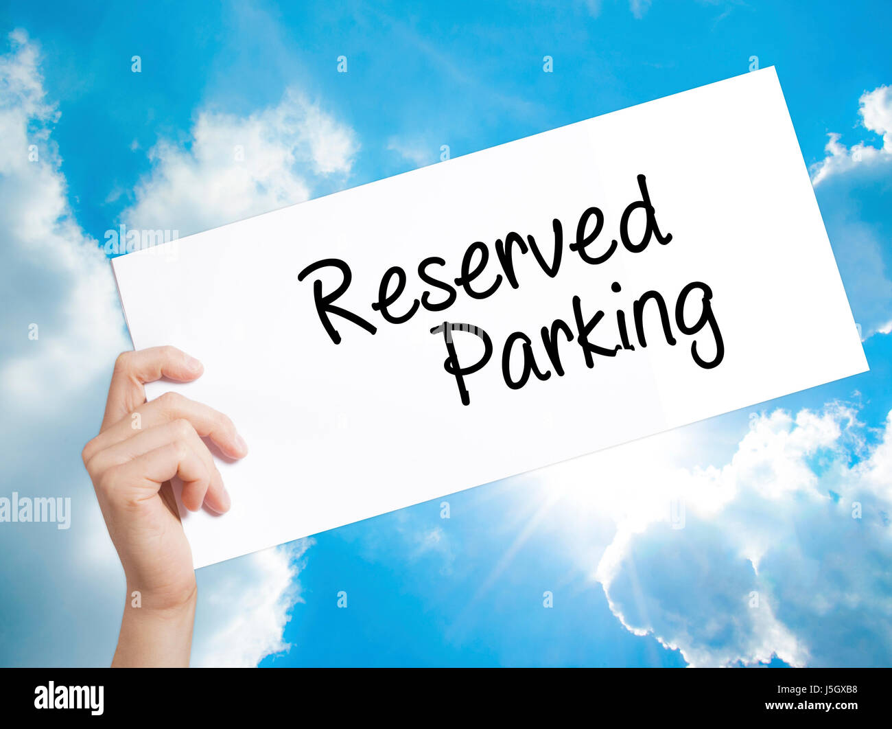 Reserved Parking Sign on white paper. Man Hand Holding Paper with text ...