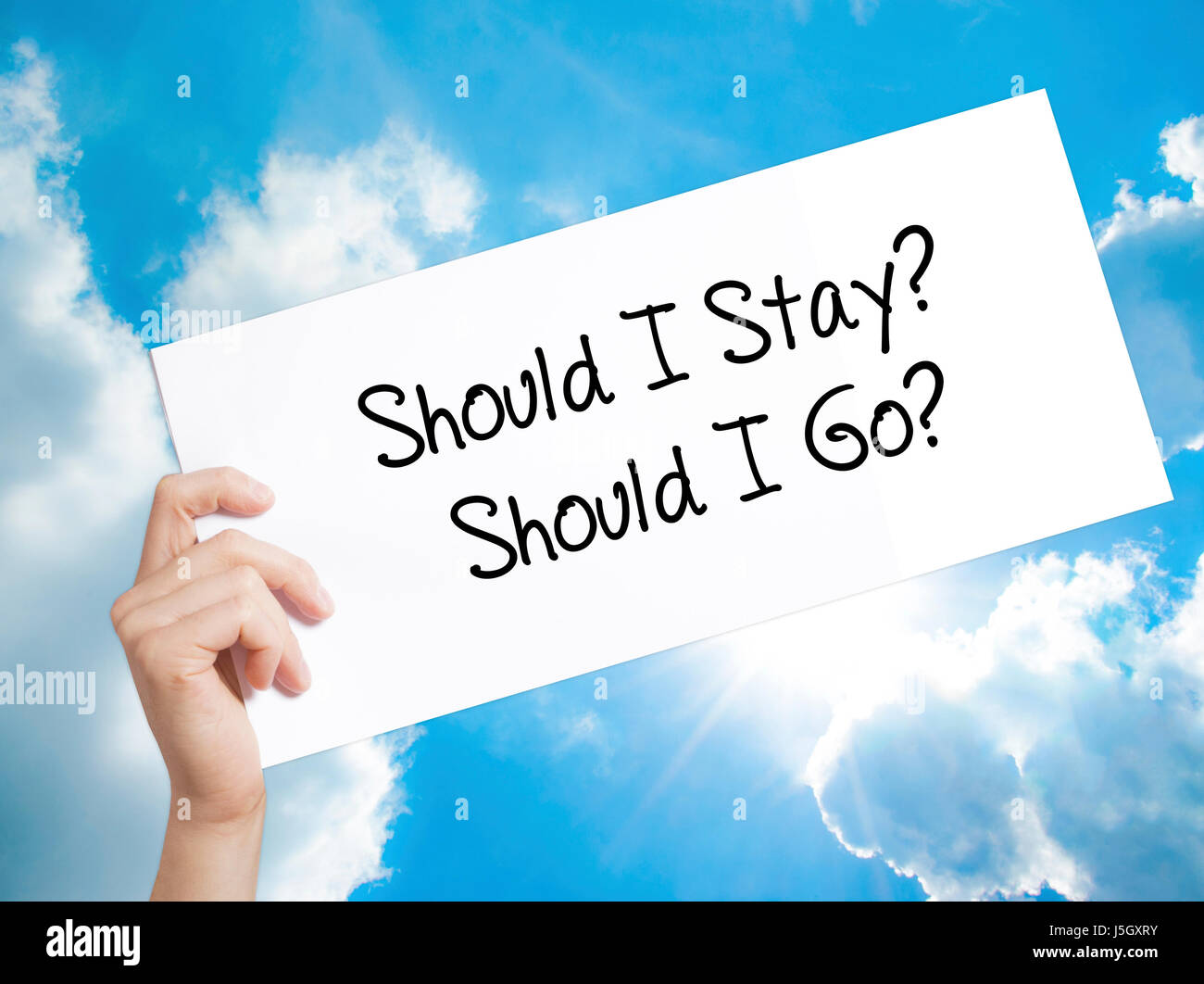 Should I Stay? Should I Go? Sign on white paper. Man Hand Holding Paper ...