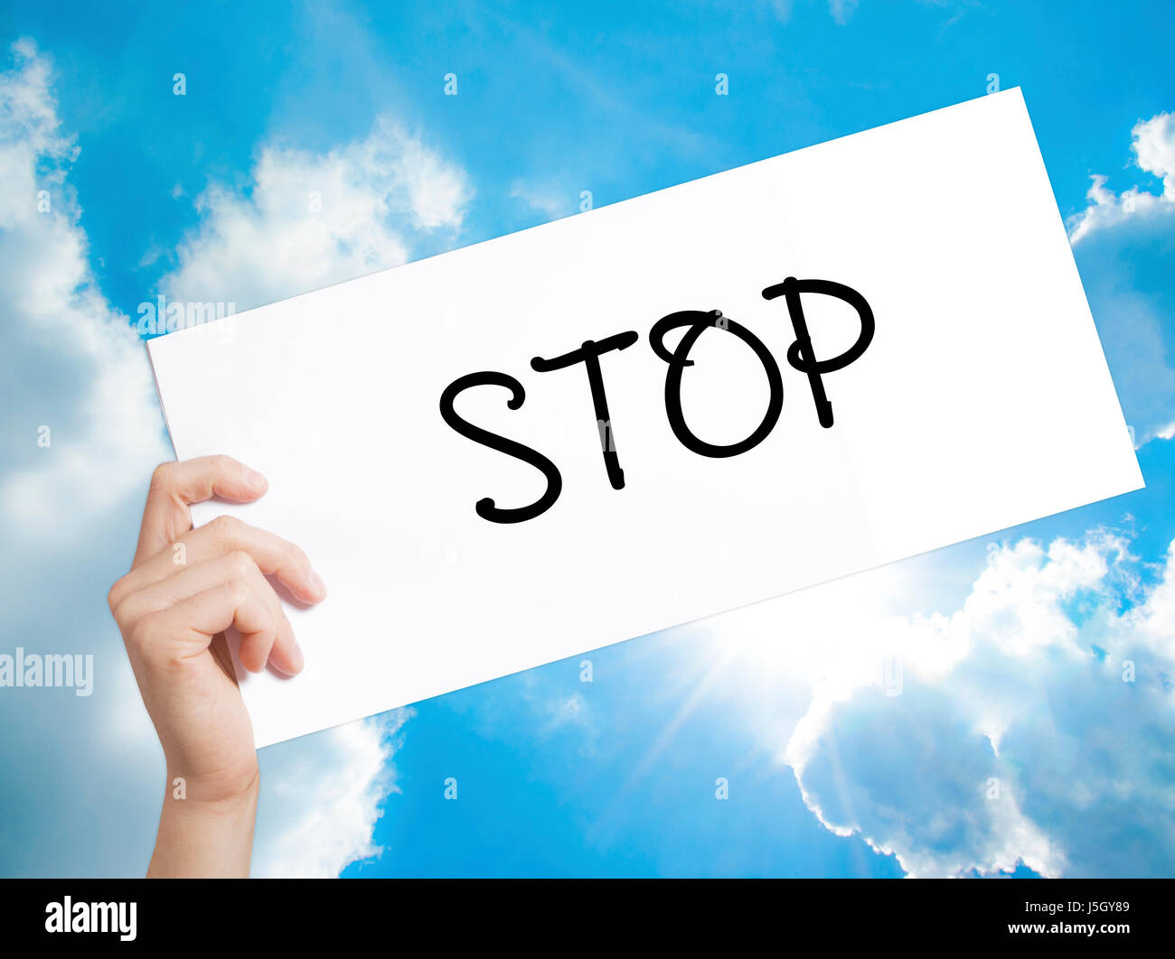 STOP Sign on white paper. Man Hand Holding Paper with text. Isolated on ...